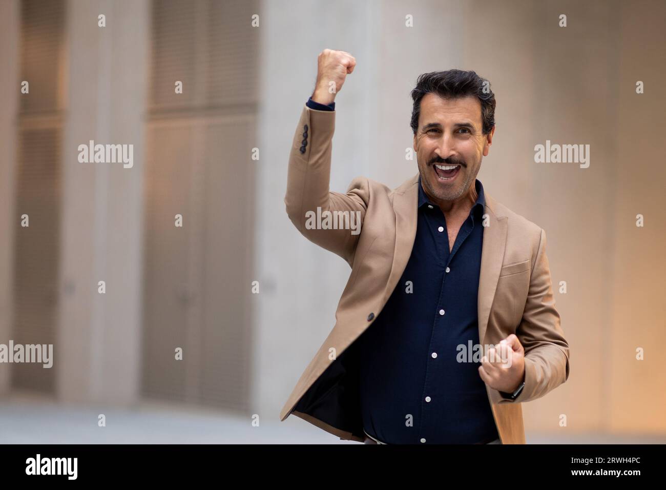 Excited happy middle eastern man raising hands up and exclaiming Stock ...