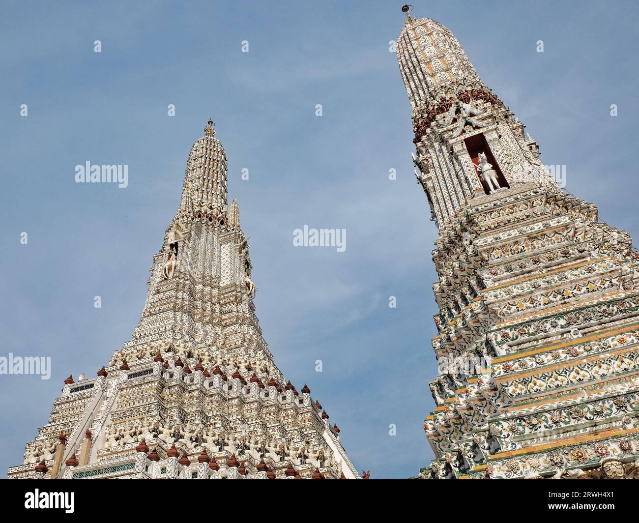 Two temple spires in Thailand. The spires are tall and ornate, with ...