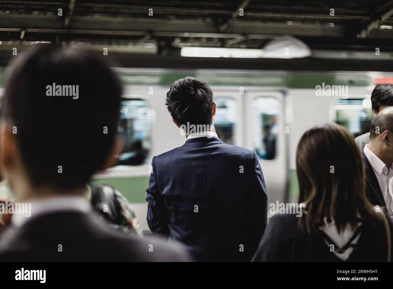 Passengers traveling by Tokyo metro. Business people commuting to work ...