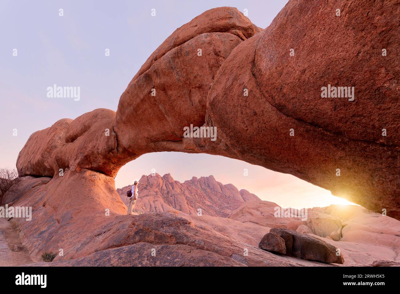 Young girl in Spitzkoppe area with picturesque stone arches and unique ...