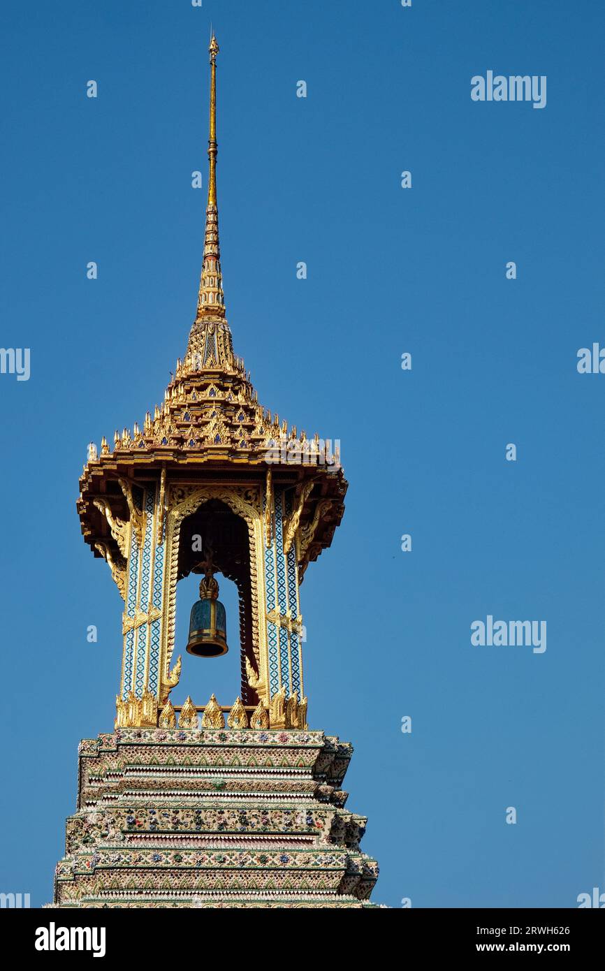 A resplendent Thai temple bell tower, crowned with a gleaming golden ...