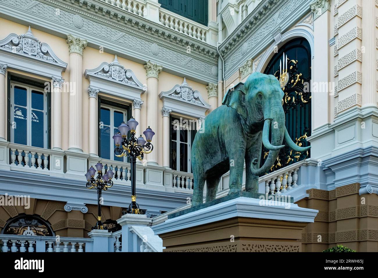 A large elephant statue, stands on an intricately patterned pedestal in ...