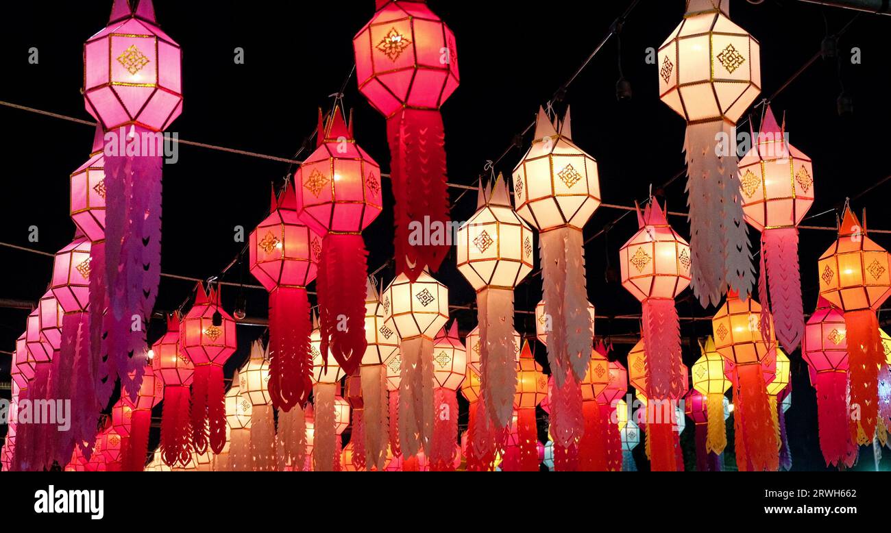 A festive display of colorful, illuminated paper lanterns hanging ...