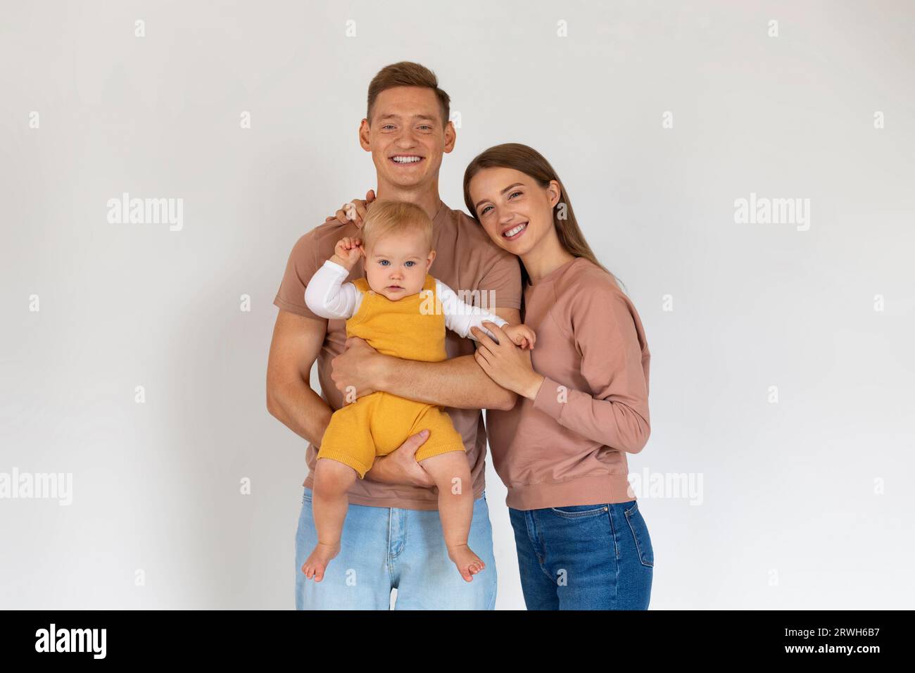 Happy Family Of Three With Cute Infant Baby Posing Over White ...