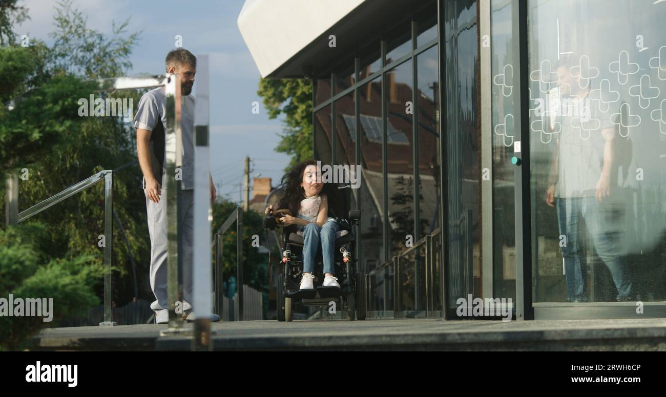 Woman with physical disability rides into clinic entrance on motorized ...