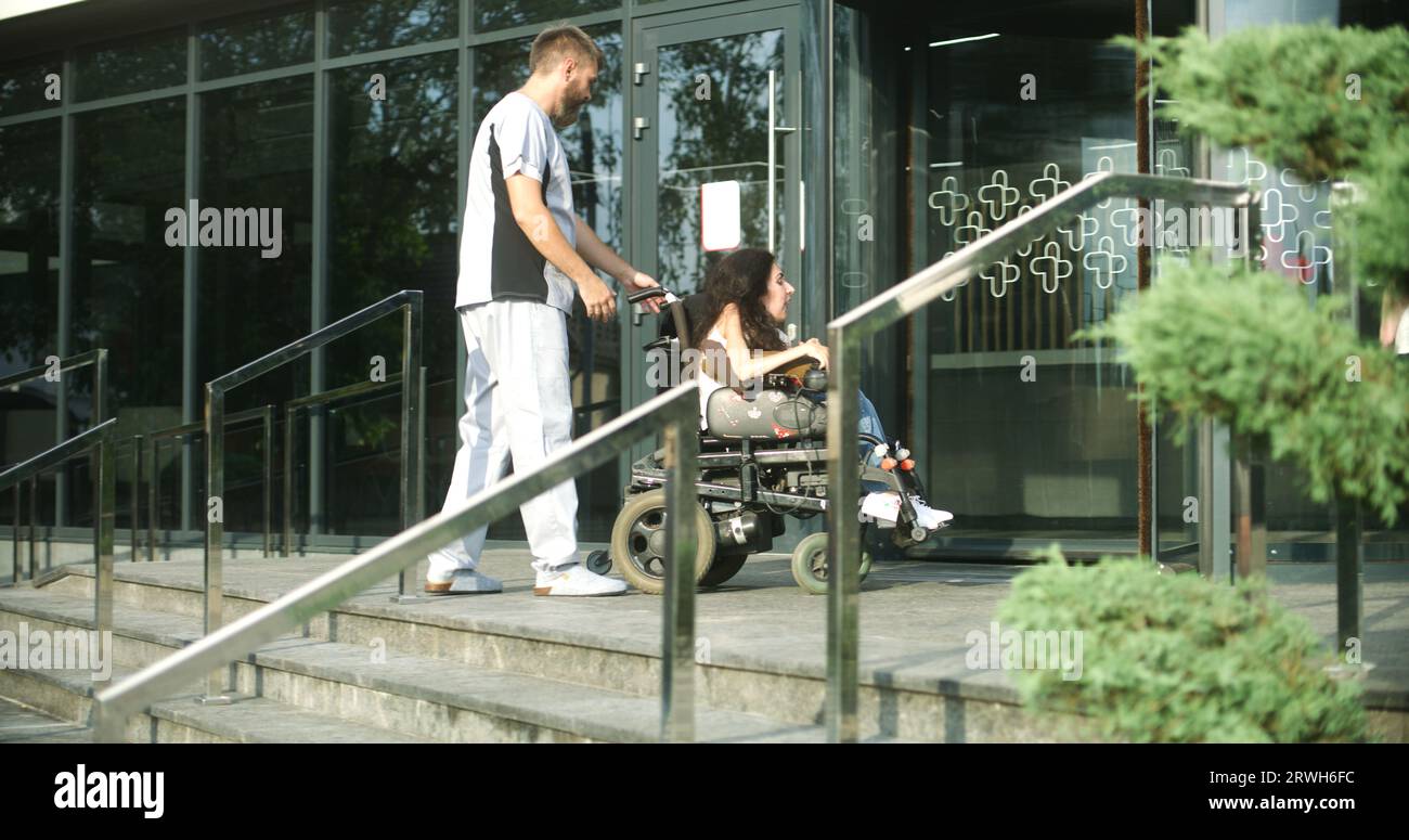 Woman with physical disability rides into clinic entrance on motorized ...