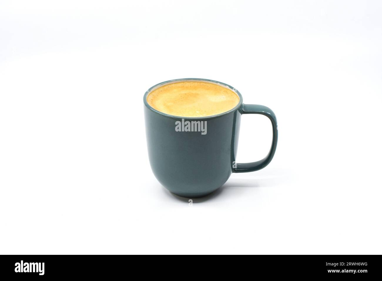 Mug of hot frothy coffee isolated on a plain white background. Copy ...