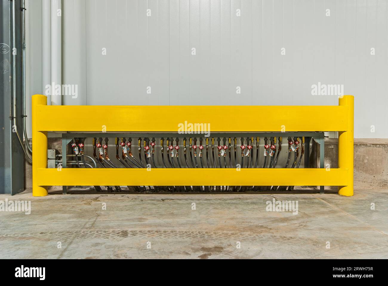Yellow guard rail and piping for floor warming on loading dock in a ...
