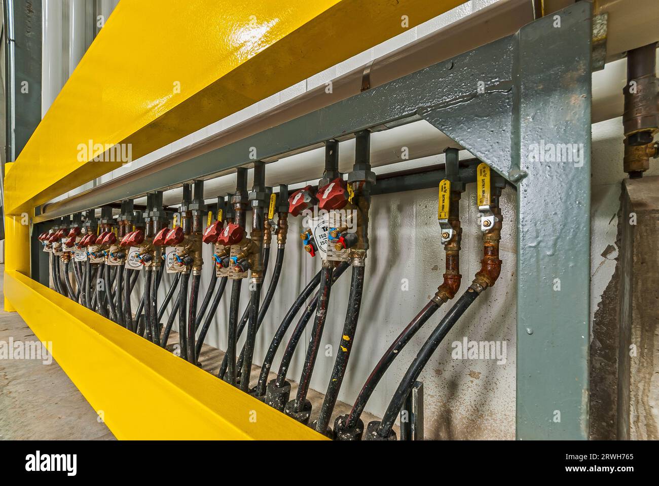 Yellow guard rail and piping for floor warming on loading dock in a ...