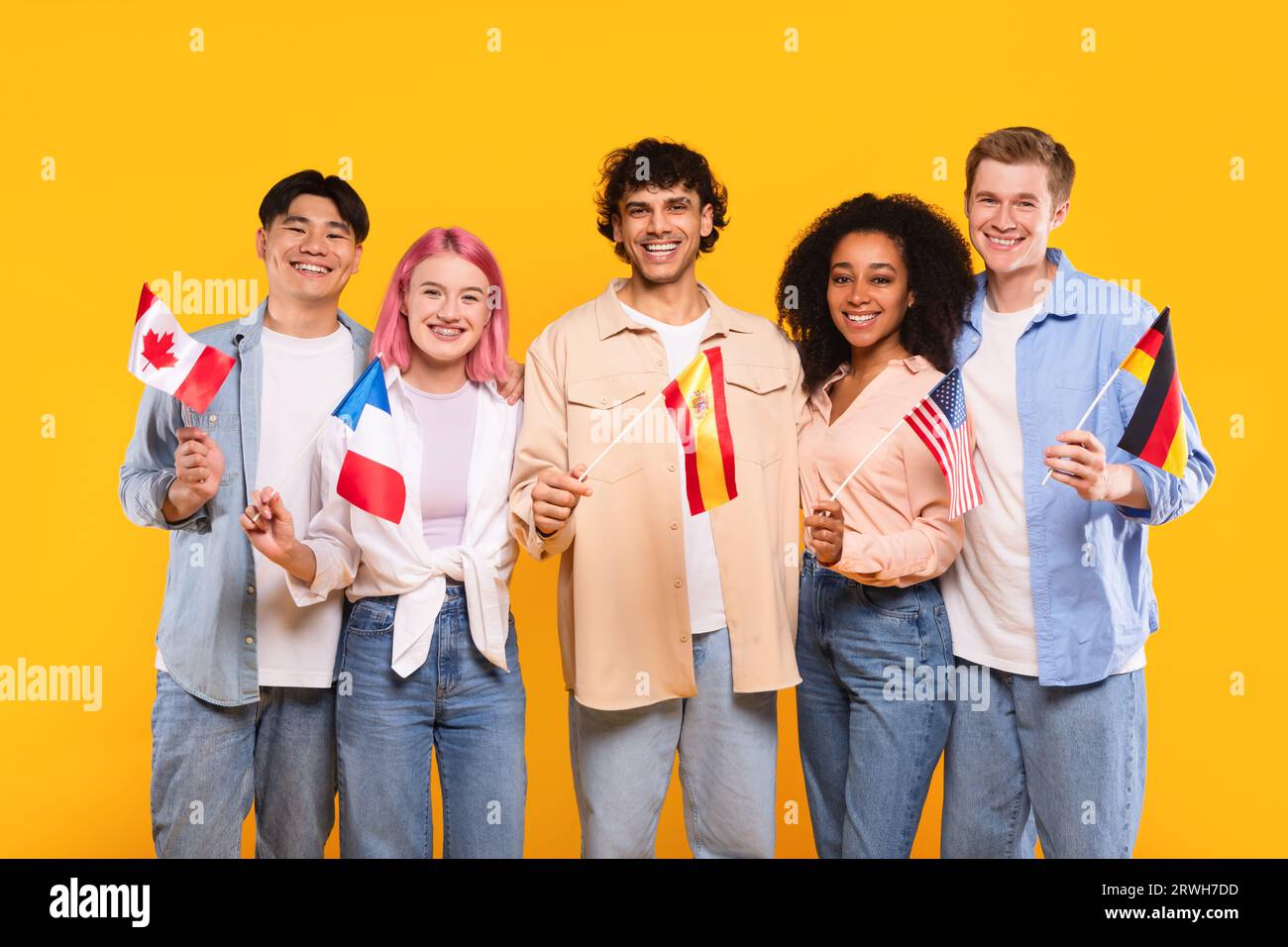 Happy multiracial people holding different countries flags and smiling ...