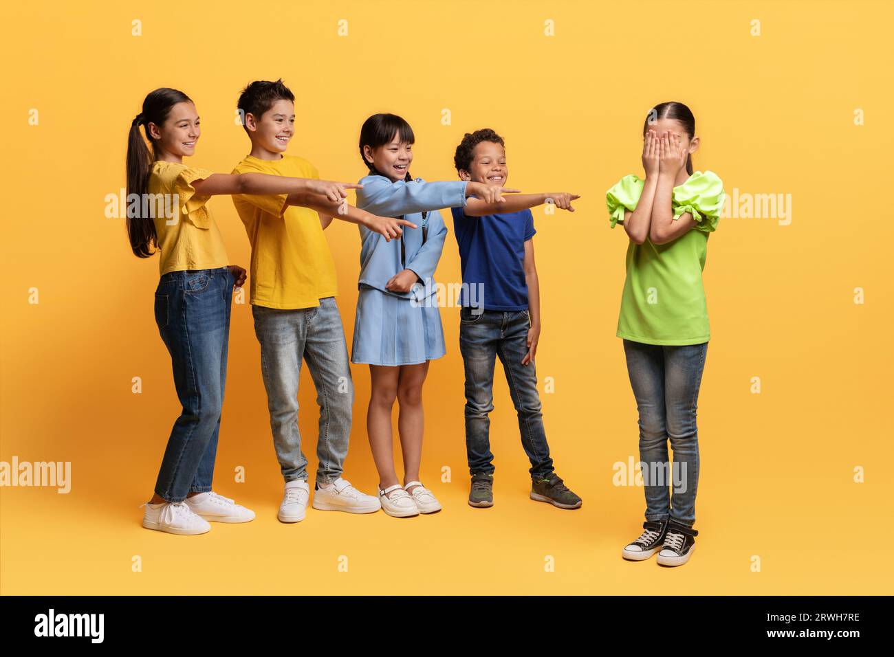 Multiracial laughing preteen kids pointing at crying girl Stock Photo ...
