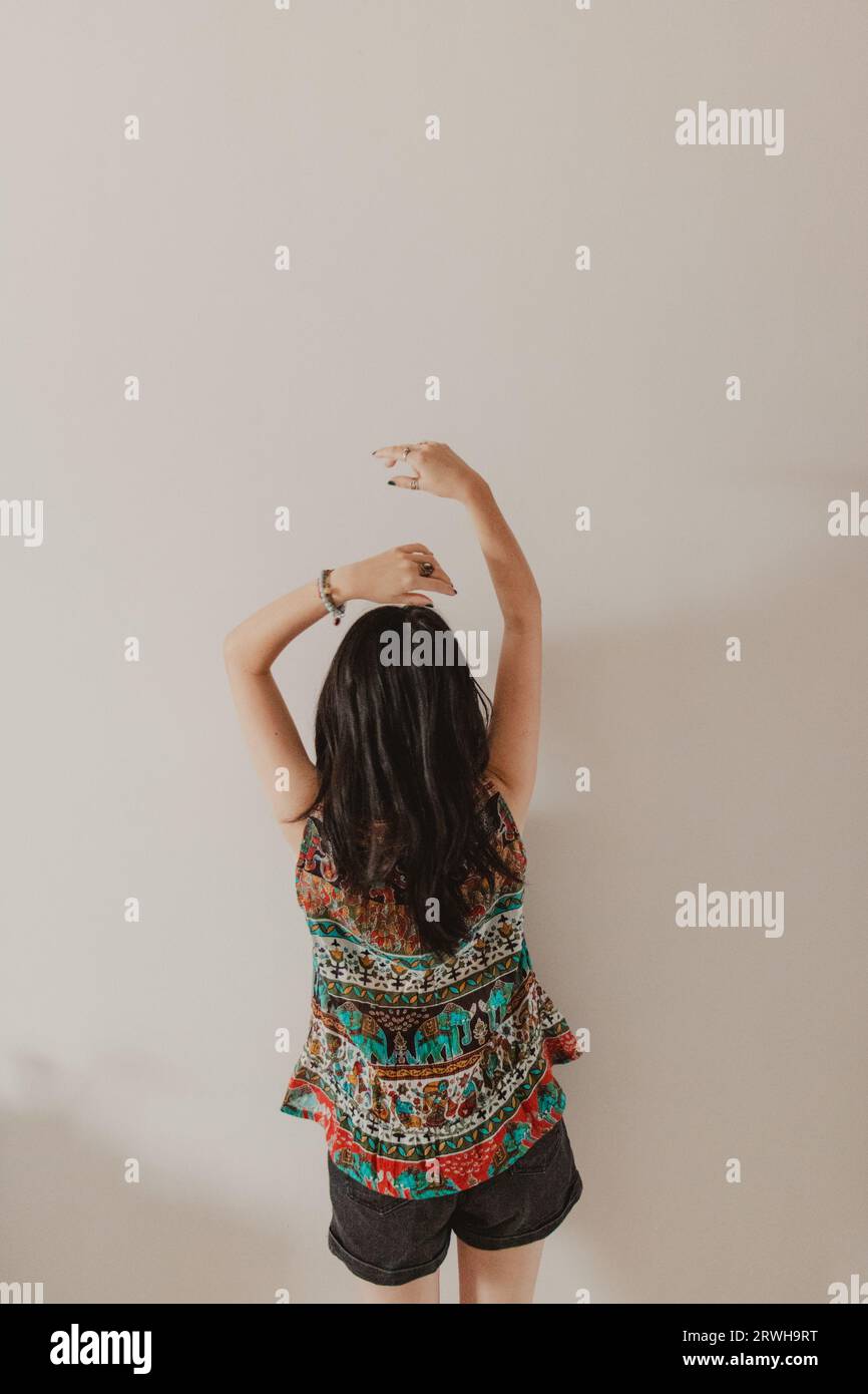 woman backwards dancing in front of a white wall Stock Photo - Alamy