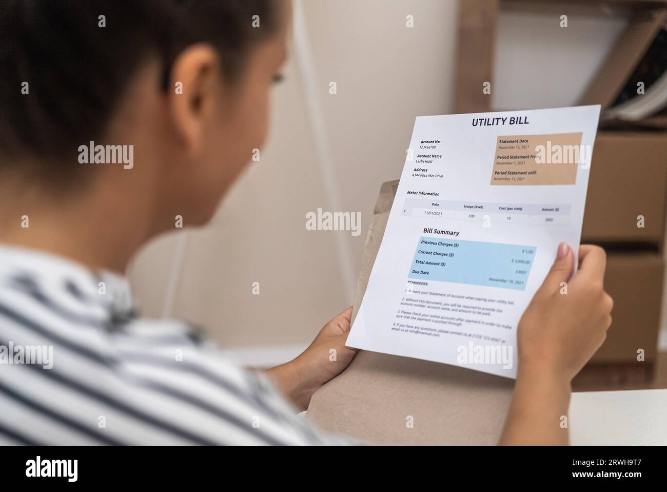 close-up woman reading utility bills and online payments through modern ...