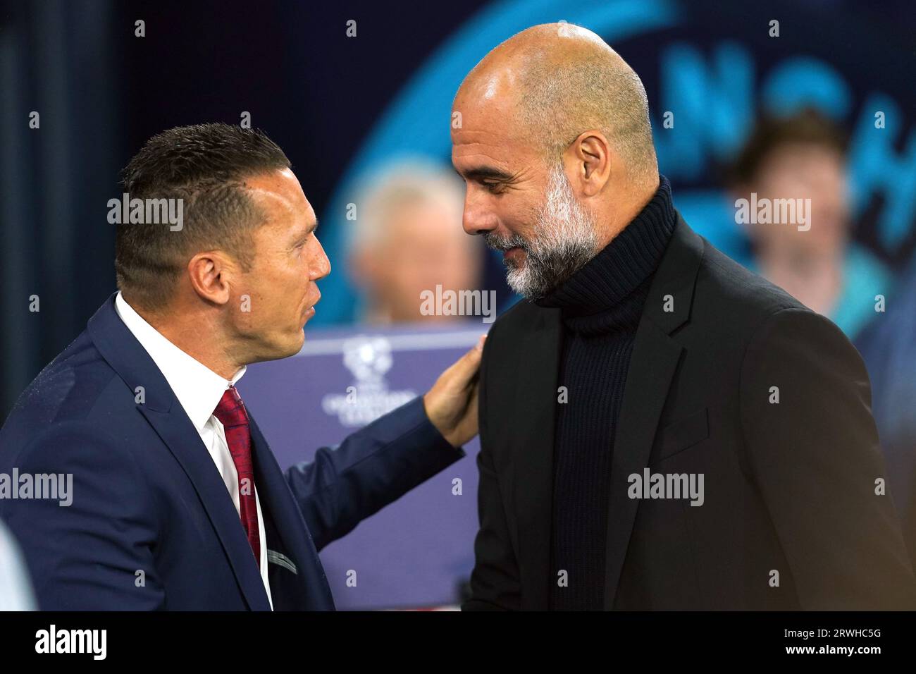 Manchester City manager Pep Guardiola (right) speaks with Red Star ...