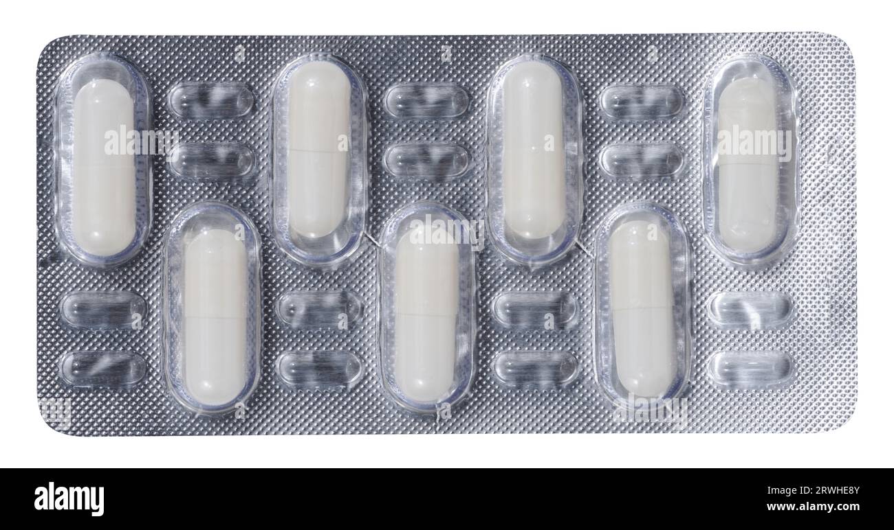 Oval white tablets in blister pack on a white isolated background, top ...