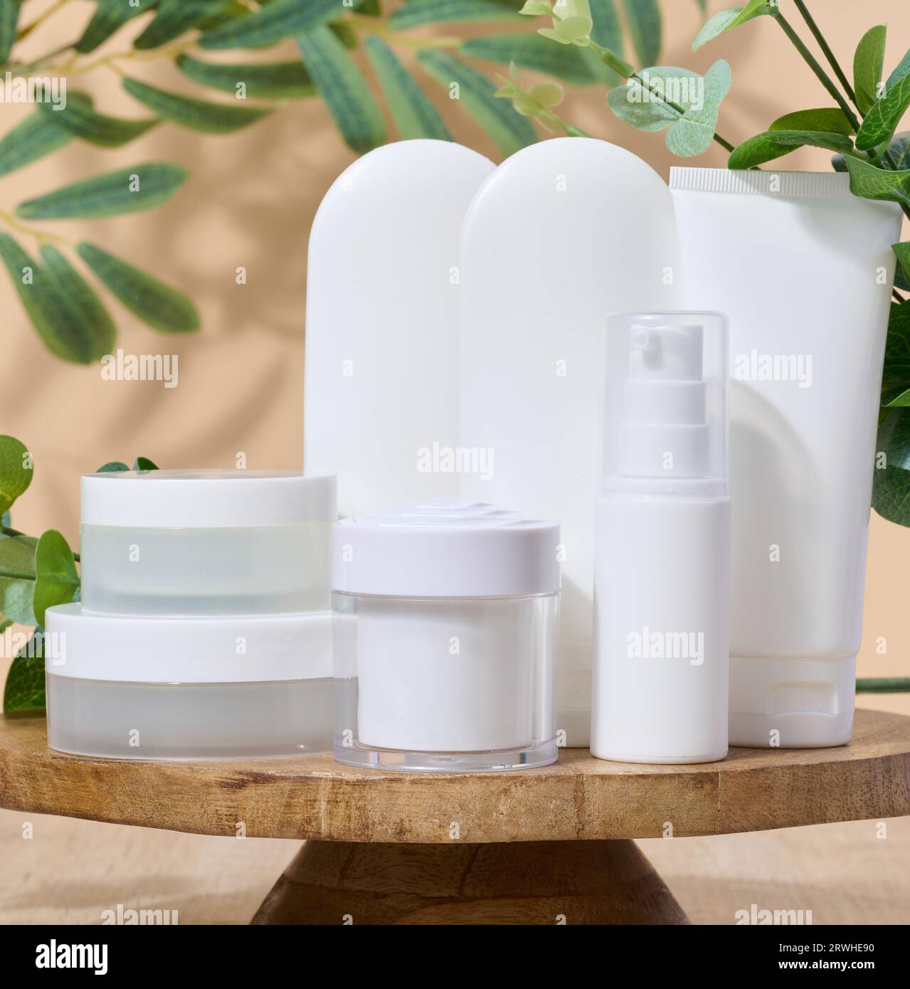 White plastic tubes and jar for cosmetic products on a white background ...