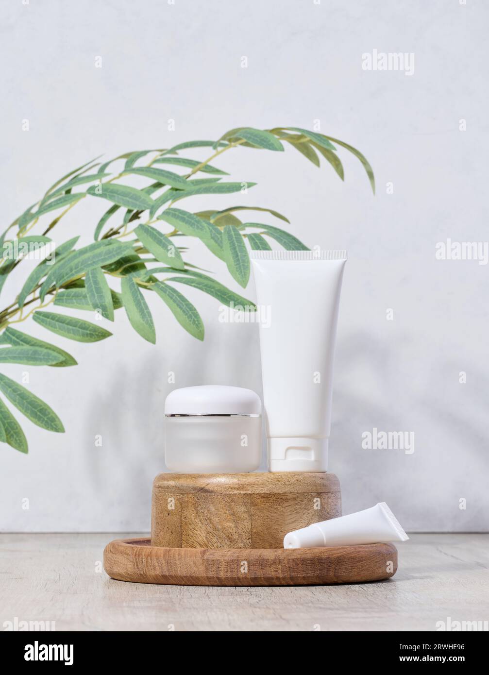 White plastic tubes and jar for cosmetic products on a white background ...