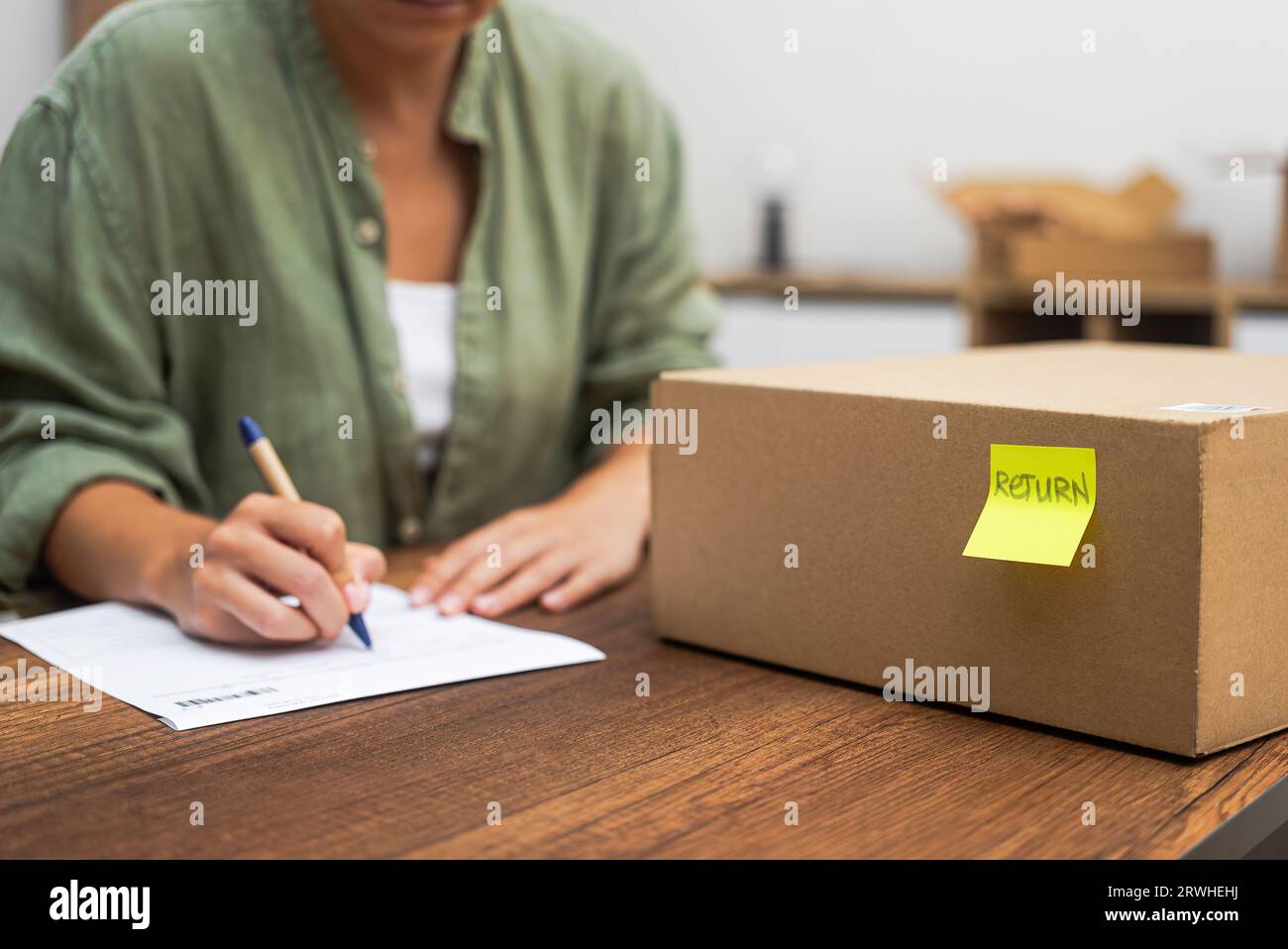 Female writes complaint about delivery near parcel with yellow sticker ...