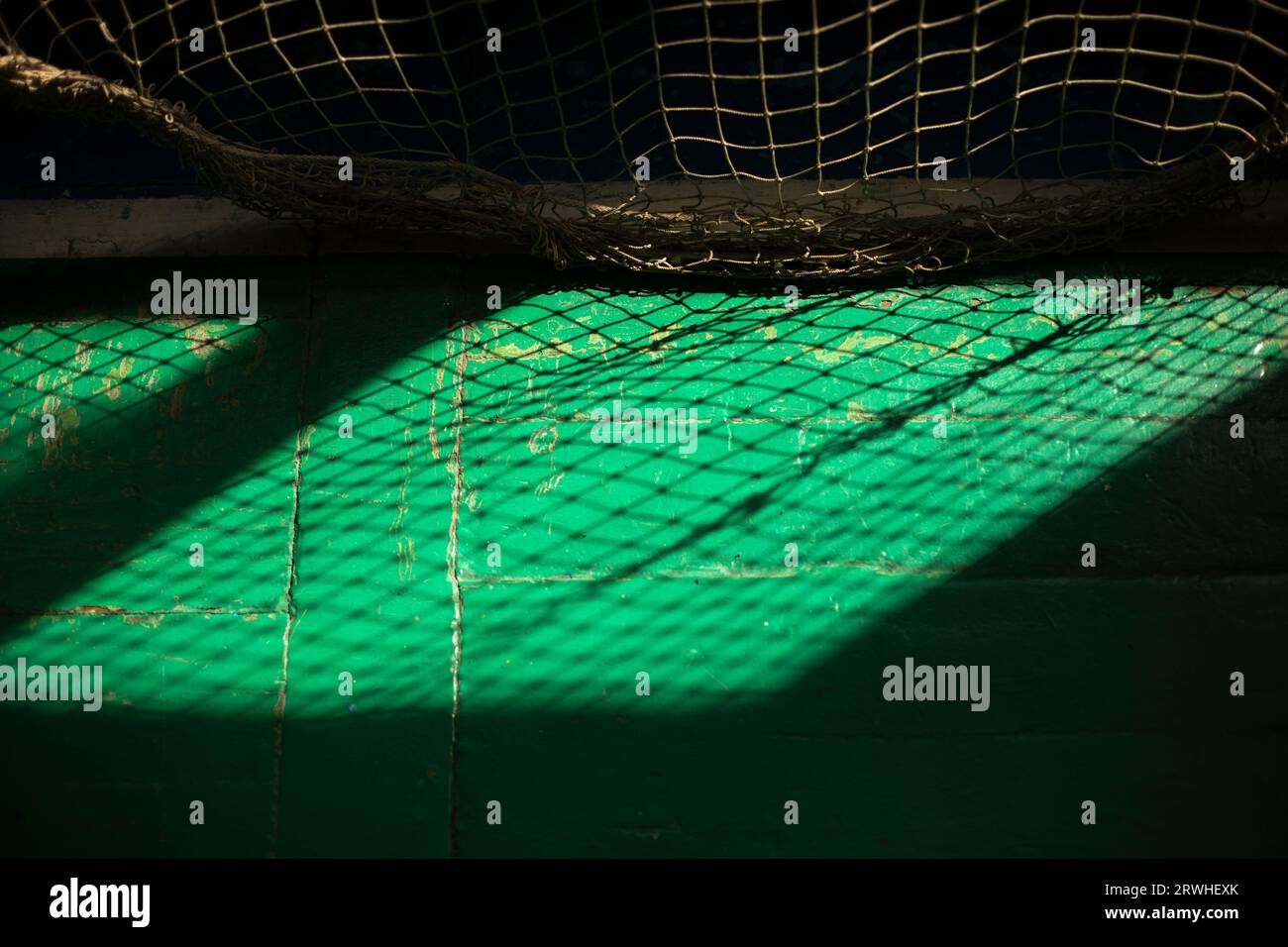 Light through grid. Light in gym. Shadow on floor. Rays from window ...
