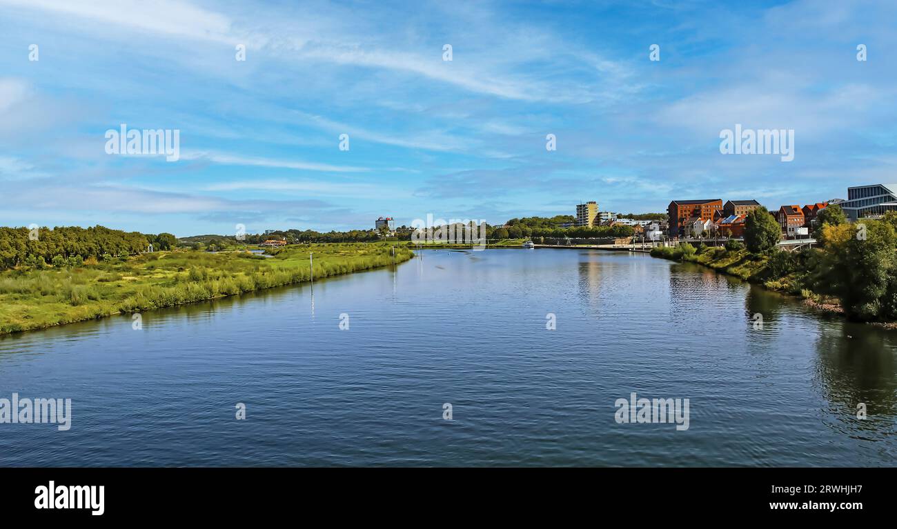River Maas panorama landscape with dutch riverside town in summer ...