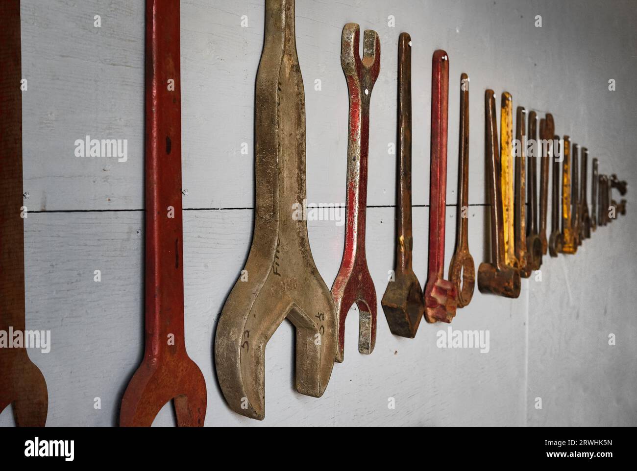 Vintage Tools Hung in Row on Wall - flaking and old Stock Photo - Alamy