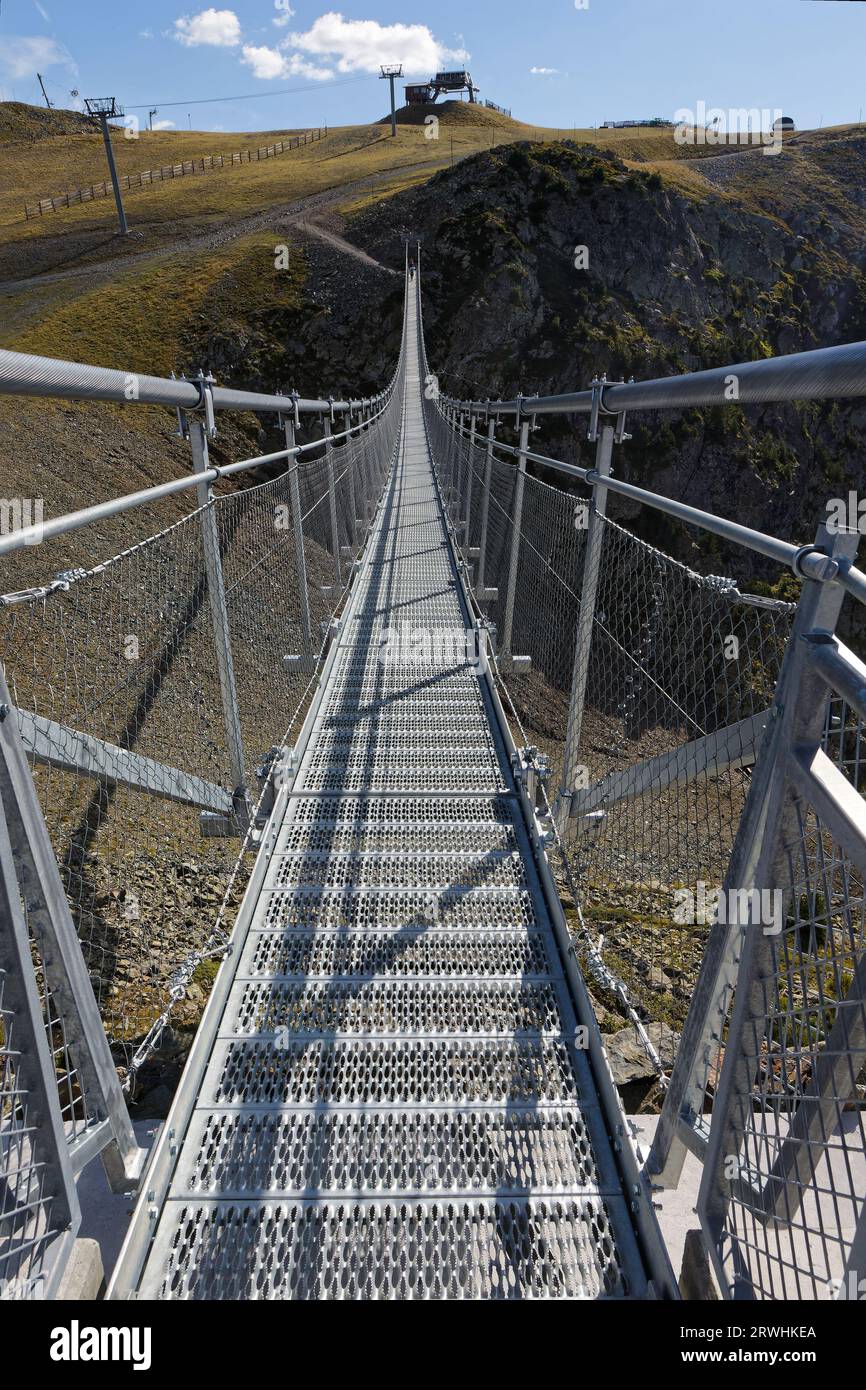 An himalayan pedestrian bridge allows hikers and tourists to access a ...