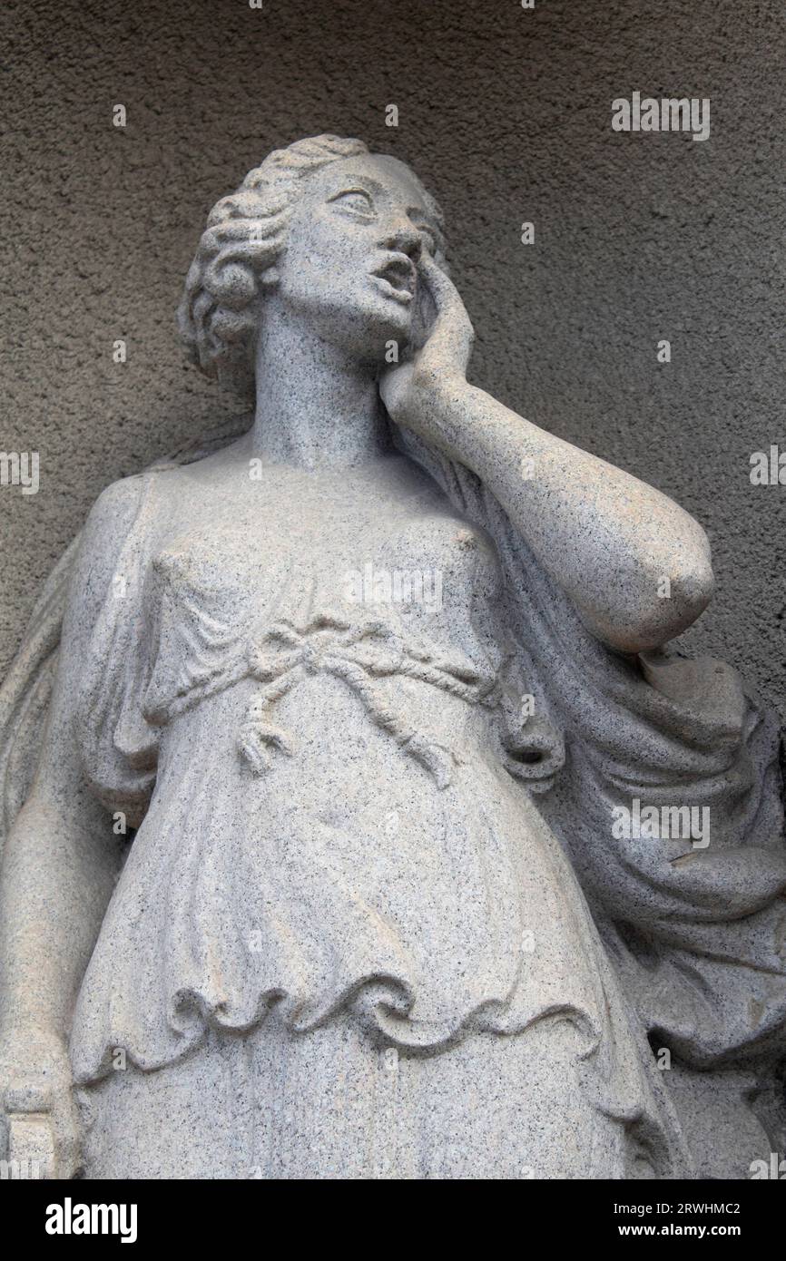 Statue of a woman with her hand to her face in a state of emotion ...