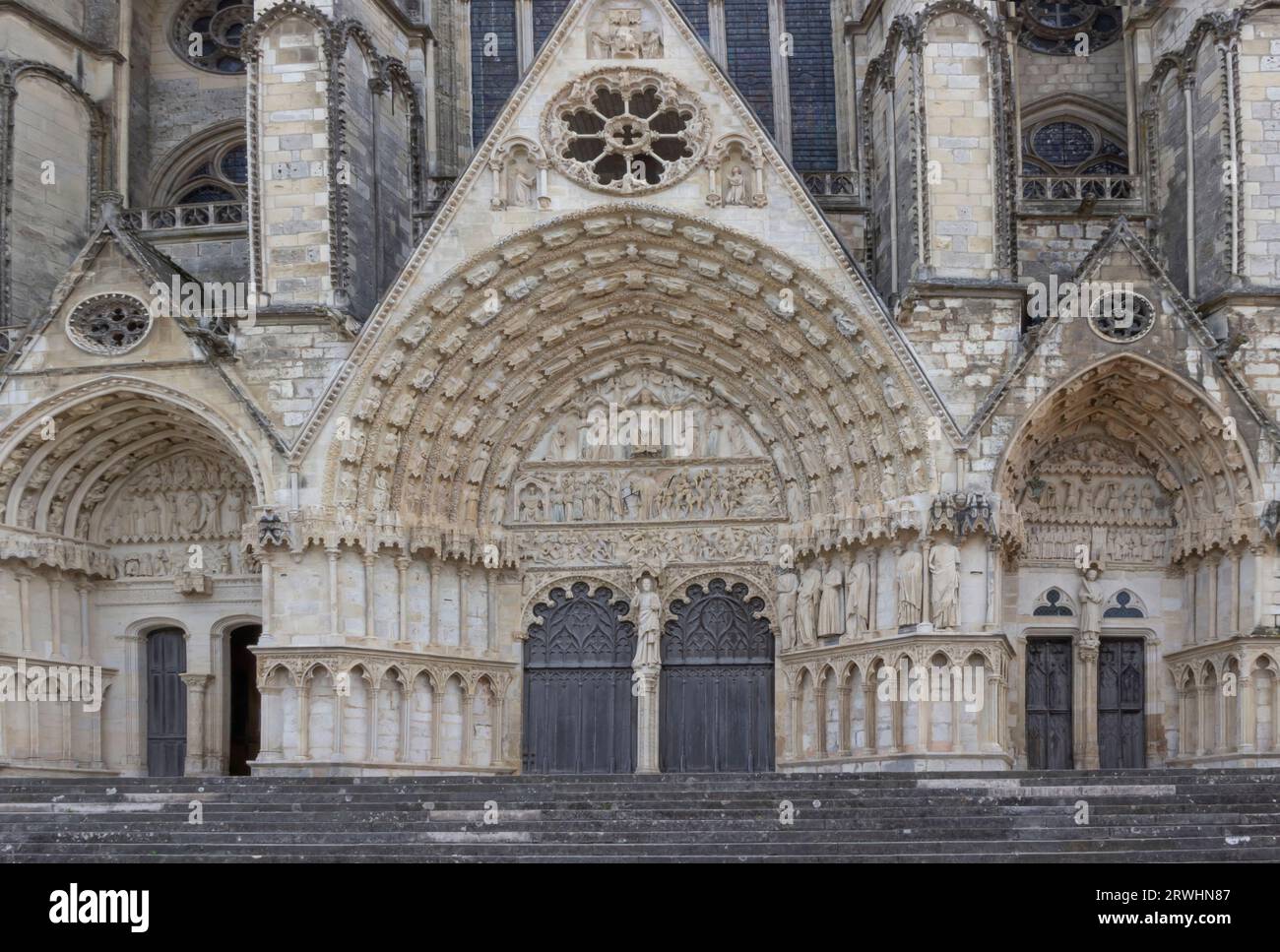 Unique and ornate front doors and steps of a church made of cream ...