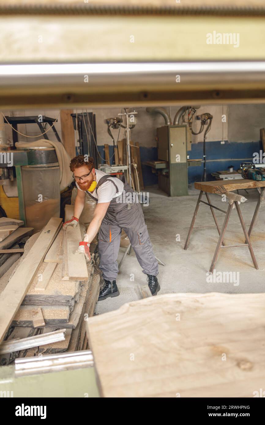 Professional male carpenter working on carpentry manufacturing with ...