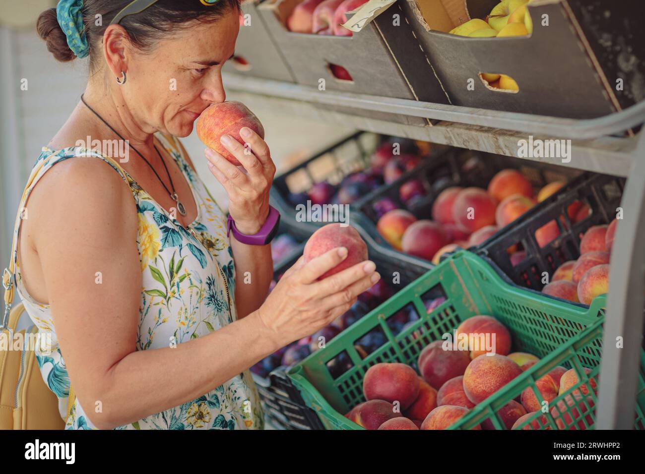 Woman smelling fruit at grocery store hi-res stock photography and ...
