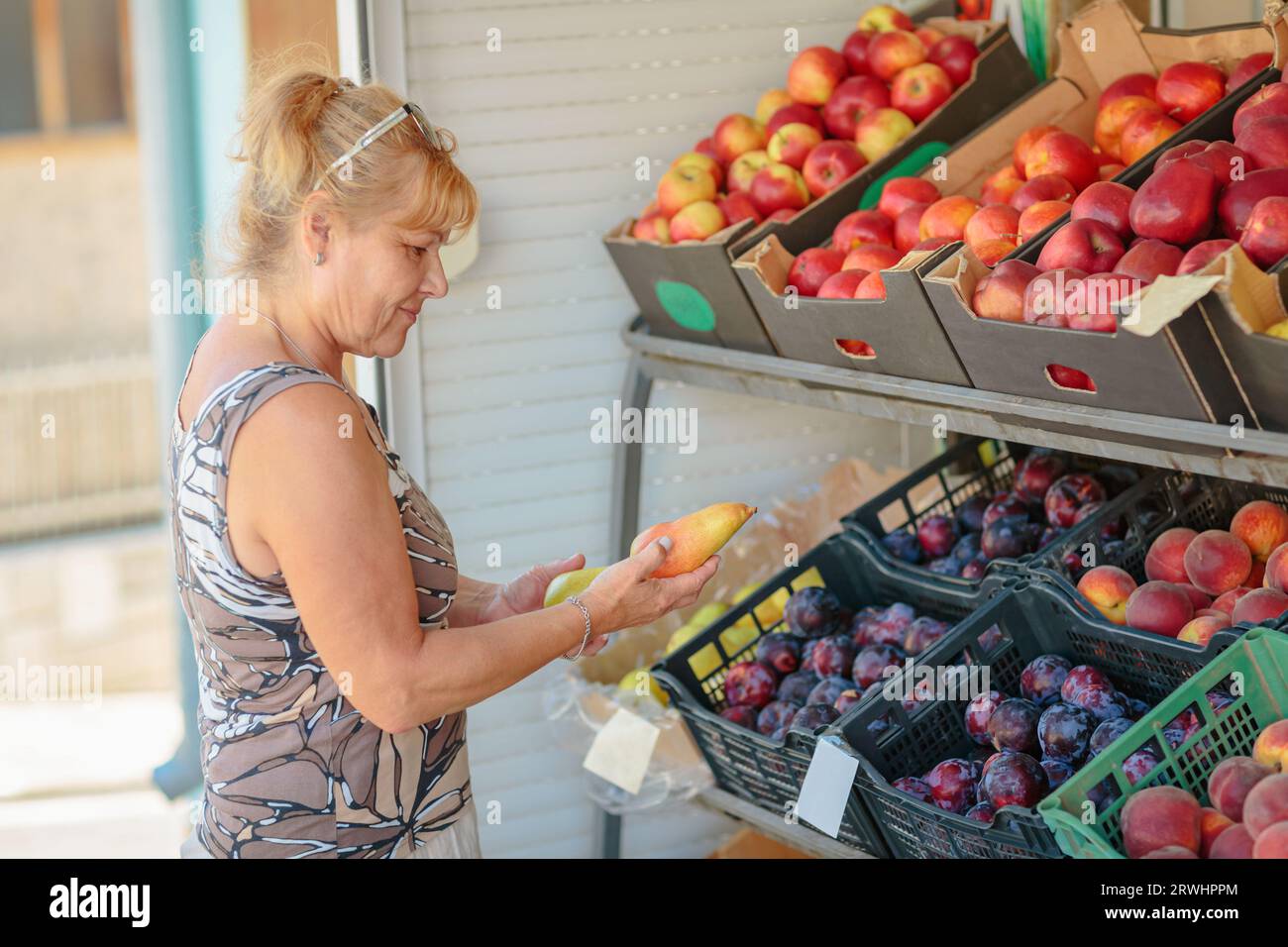 Mature woman choosing fruit hi-res stock photography and images - Alamy