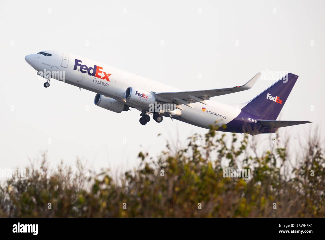 Cargo aircraft of FedEx Express ascending to sky from Barcelona Stock ...