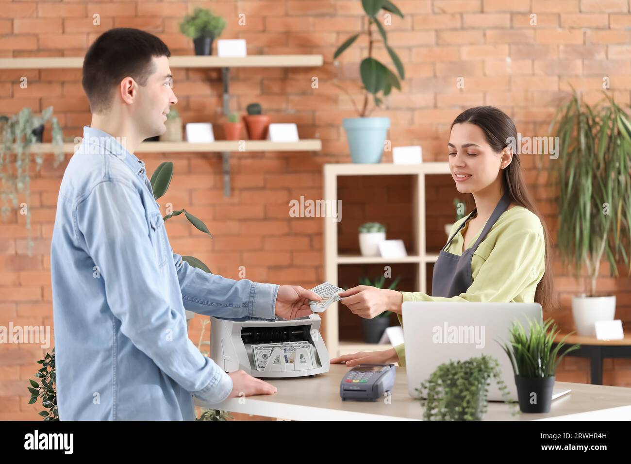 Woman counter cash receiving hi-res stock photography and images - Alamy