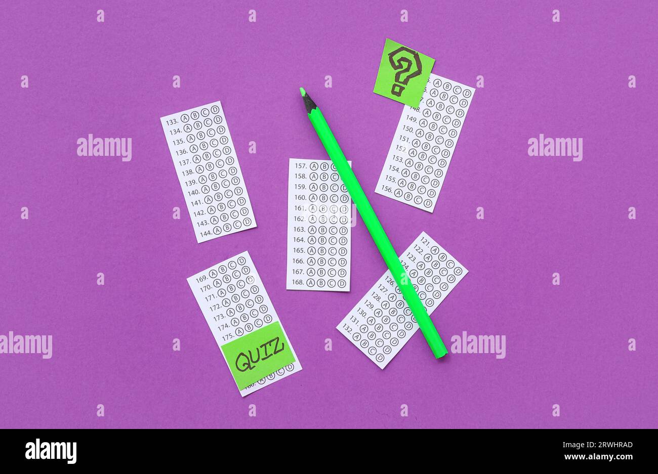 Quiz forms with marker and card on purple background Stock Photo - Alamy