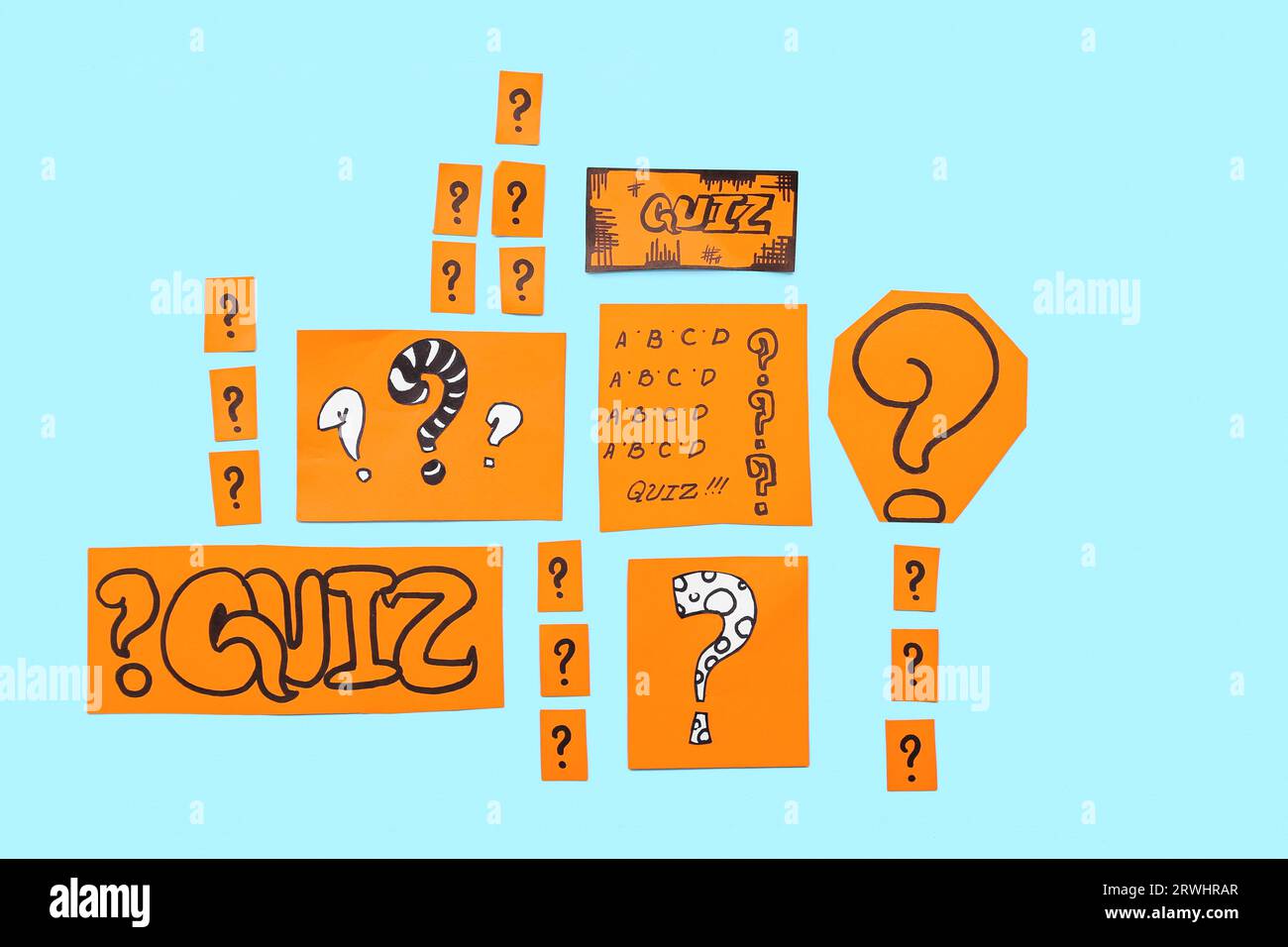 Paper quiz cards and question marks on blue background Stock Photo - Alamy