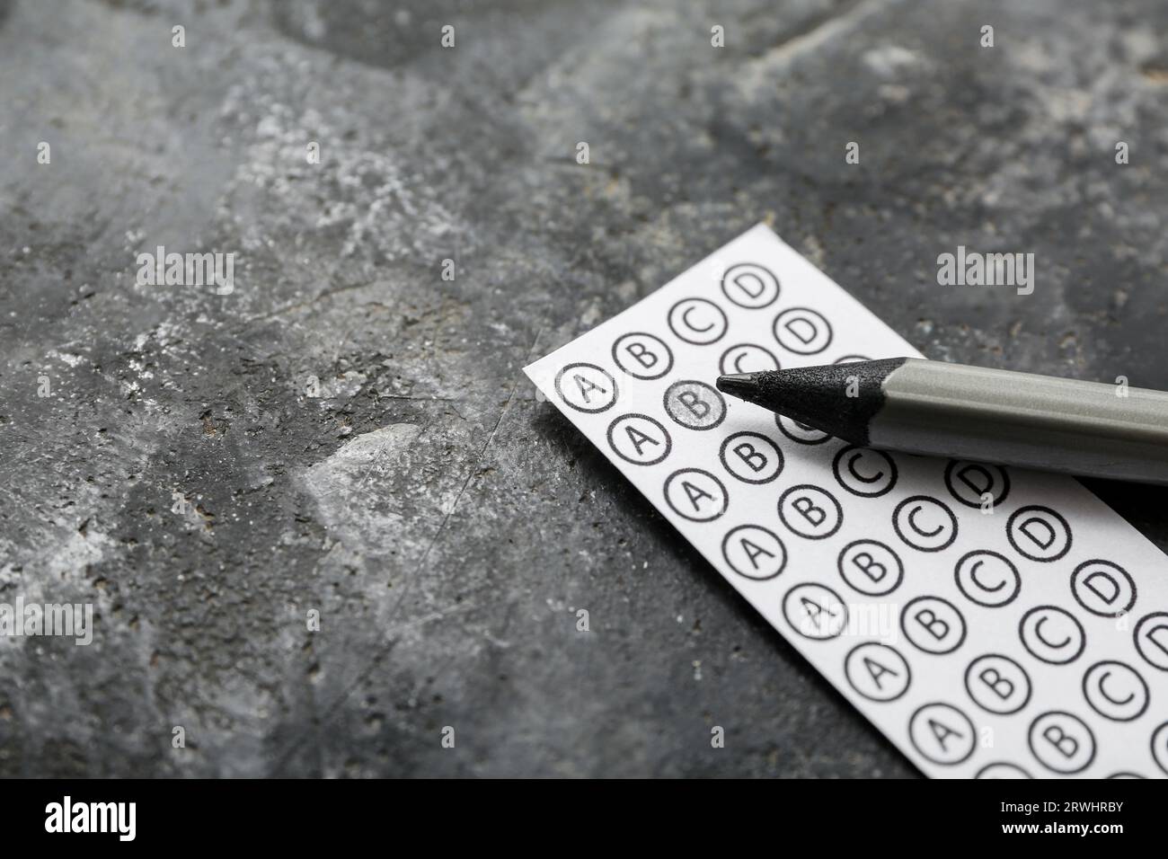 Quiz form with pencil on grunge black background Stock Photo - Alamy