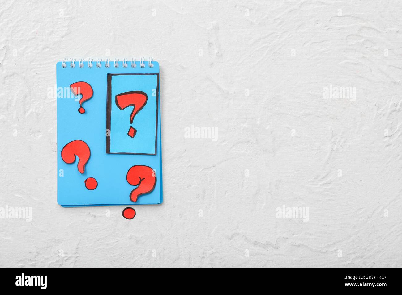 Notebook with quiz card and question marks on white background Stock ...