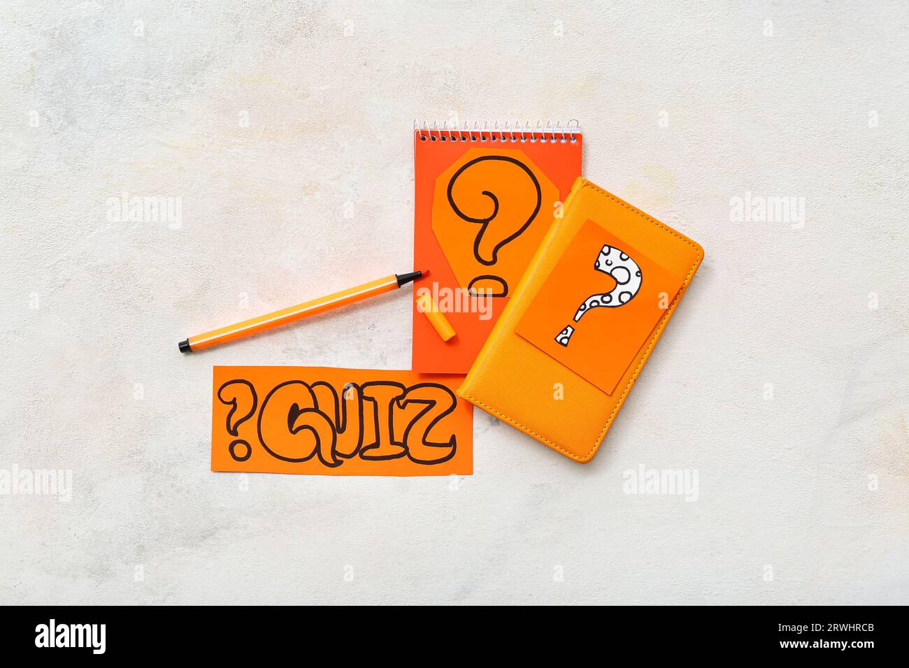 Notebooks and quiz cards with question marks on grunge white background ...