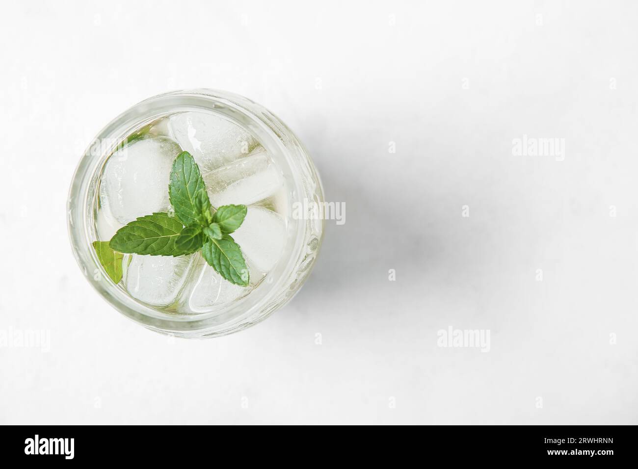 Glass of fresh icy mint tea on white background Stock Photo - Alamy