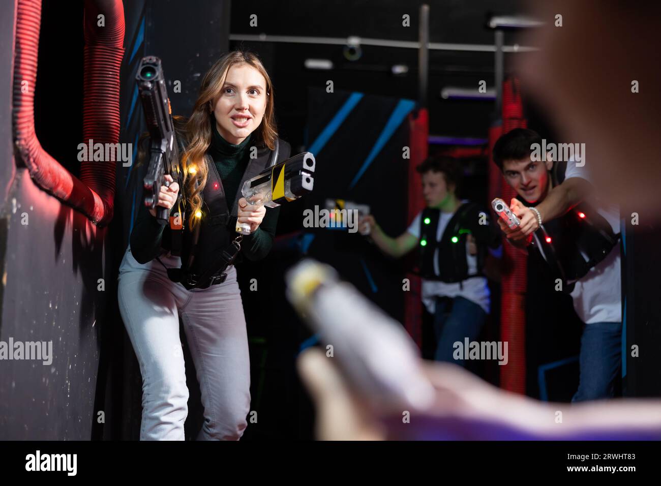 Young lady having fun playing lasertag in arena Stock Photo - Alamy