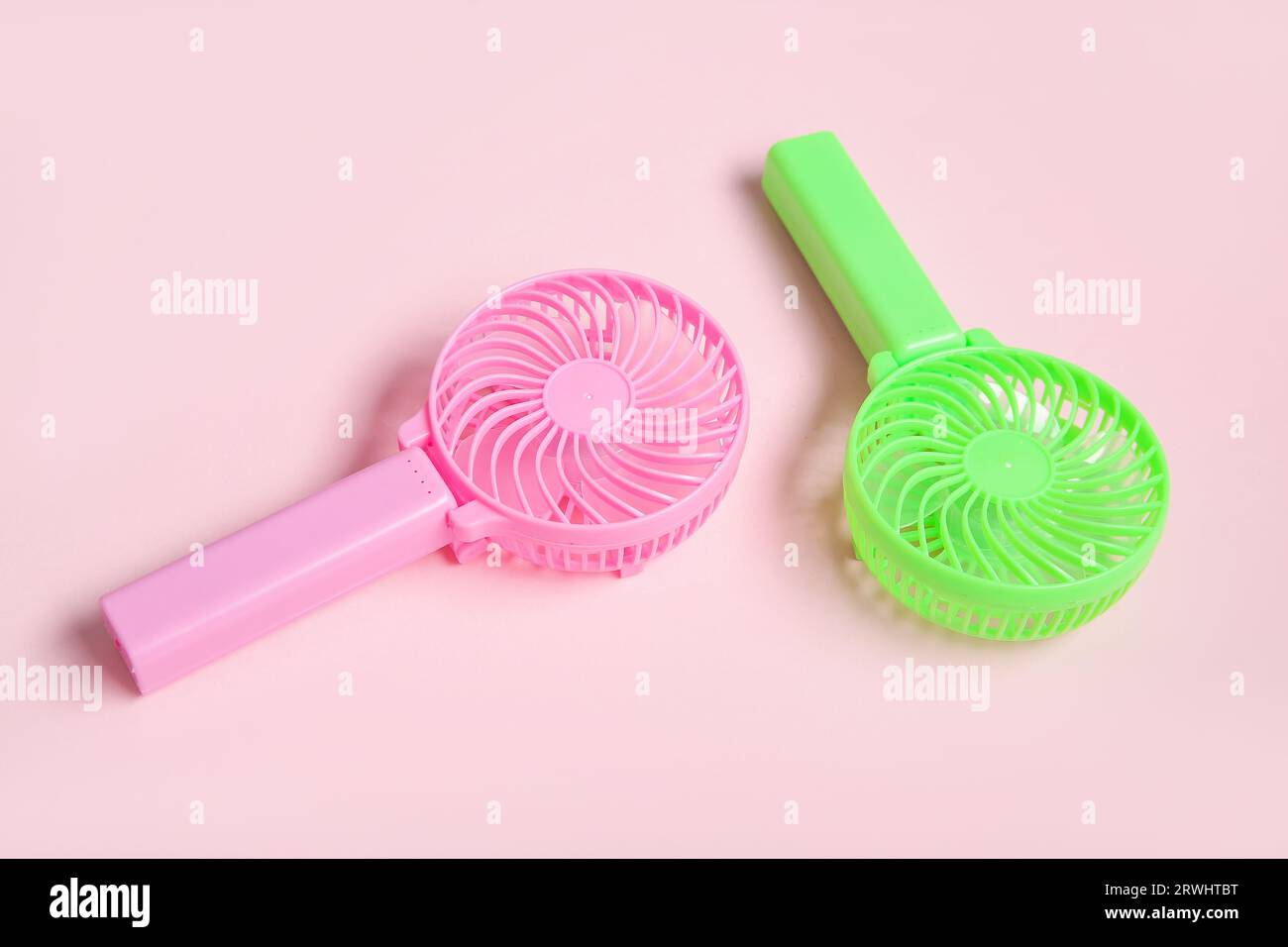 Different portable electric fans on pink background, closeup Stock ...