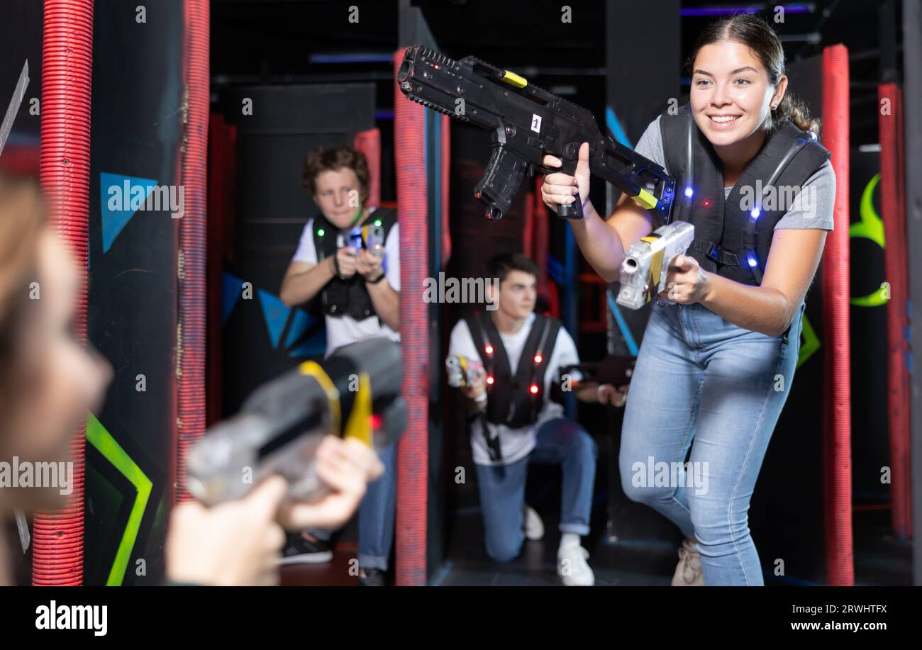 Young woman playing lasertag in arena Stock Photo - Alamy