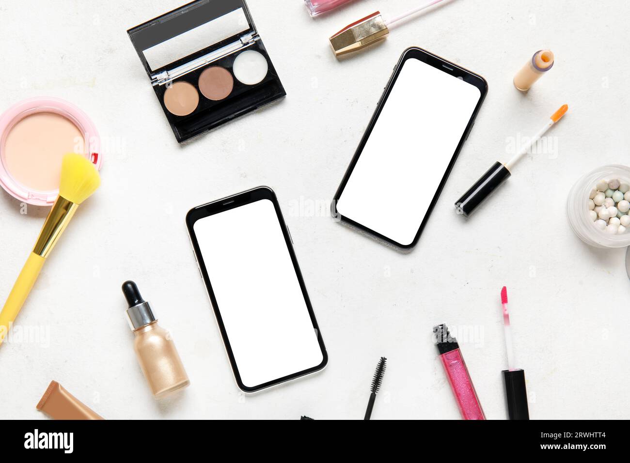 Composition with mobile phones and different cosmetic products on light ...