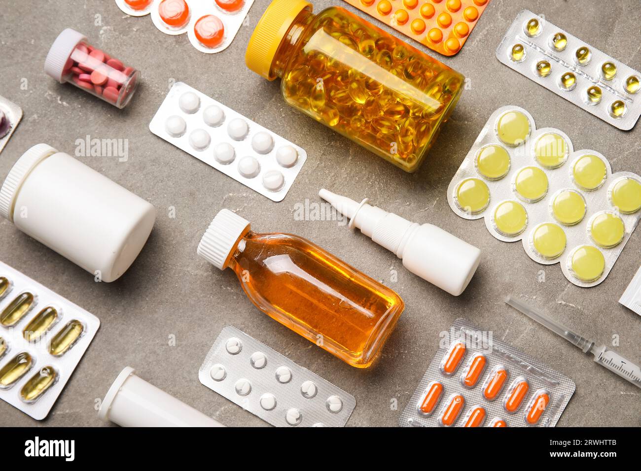 Different pills and bottles of medicines on grey background Stock Photo ...