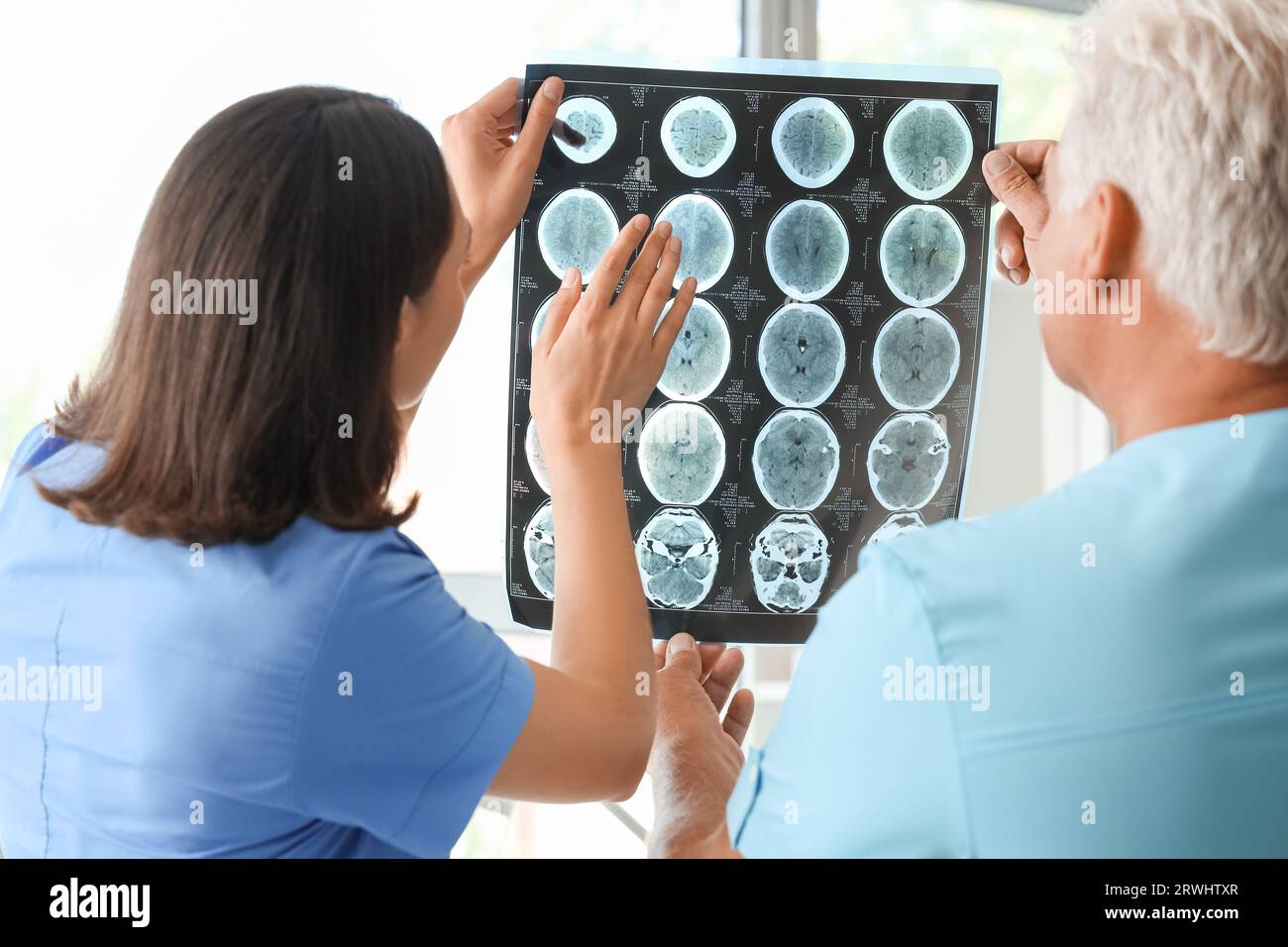 Doctors examining x-ray scan in clinic, back view Stock Photo - Alamy