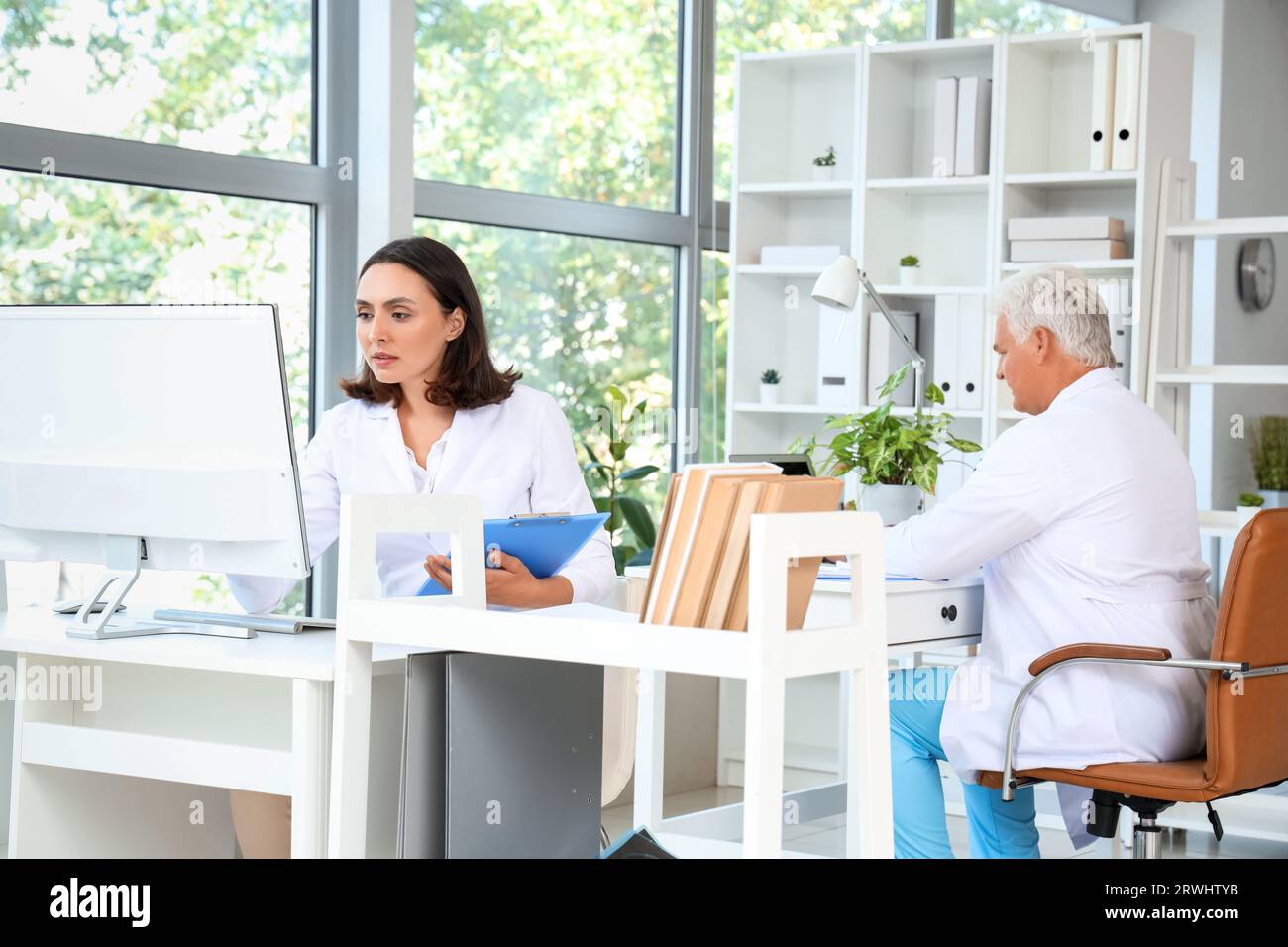Doctors working at their workplaces in medical office Stock Photo - Alamy