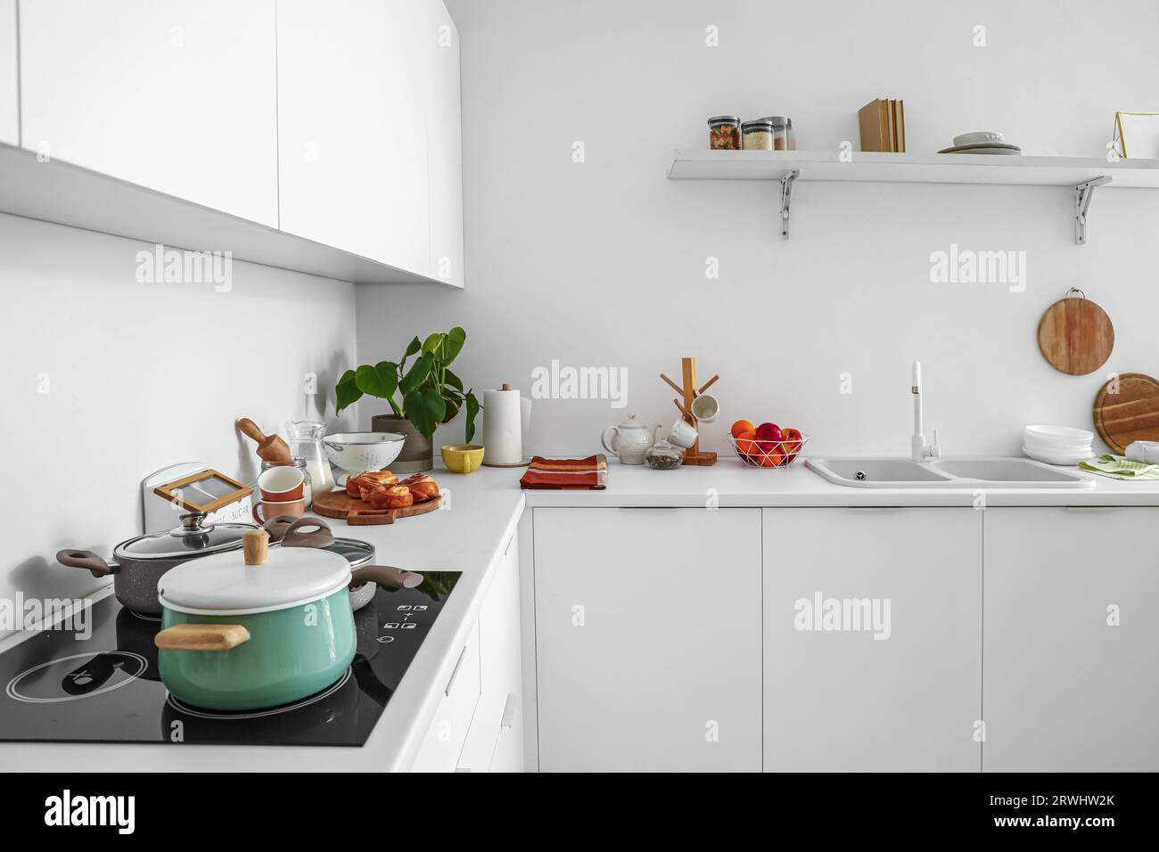 Interior of light kitchen with modern electric stove and utensils Stock ...