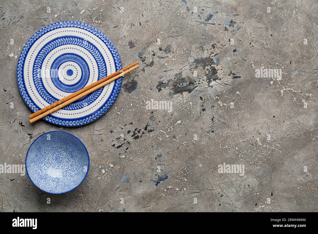 Chinese table setting on grunge background Stock Photo - Alamy