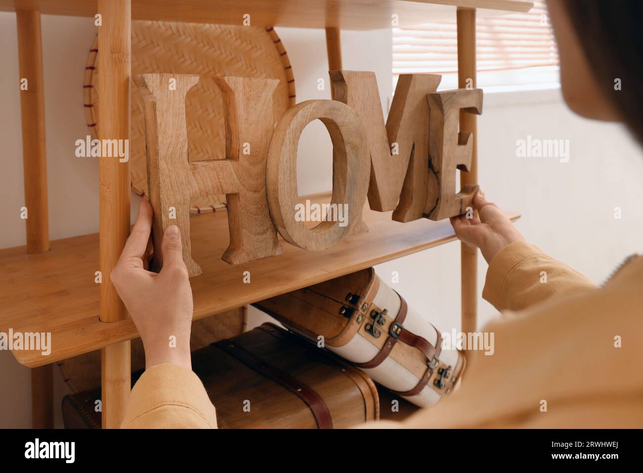 Woman decorating shelving unit hi-res stock photography and images - Alamy
