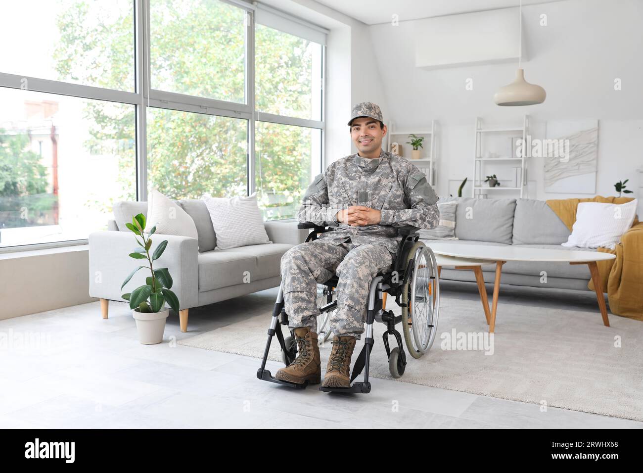 Young soldier in wheelchair at home Stock Photo - Alamy